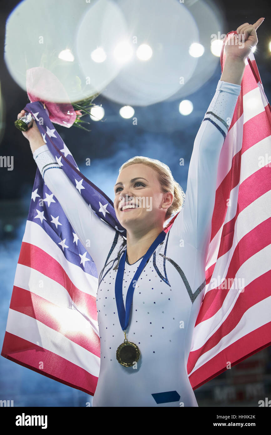Smiling female gymnast celebrating victory holding American flag Stock ...