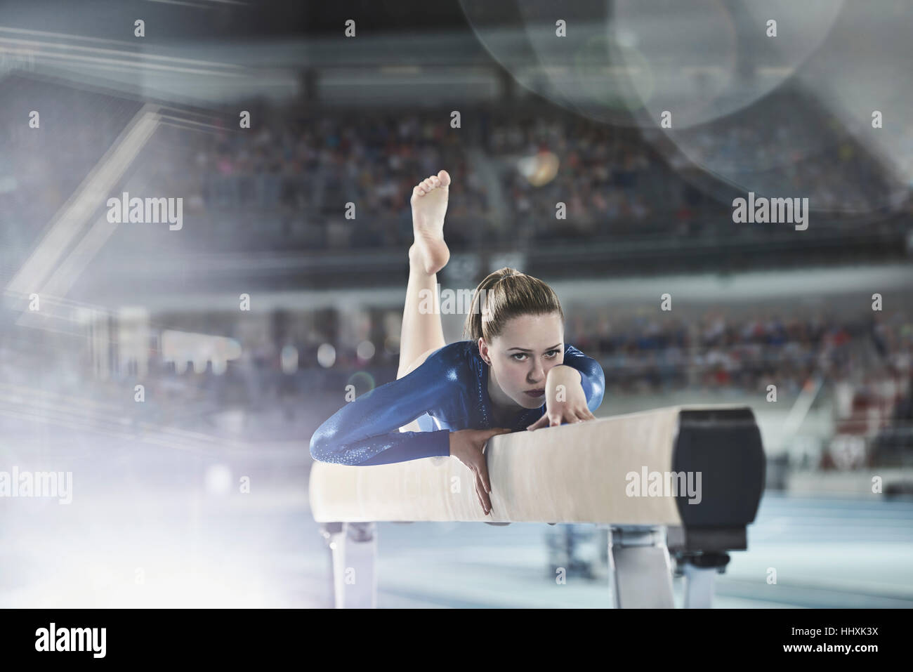Female gymnast practicing on balance beam in arena Stock Photo - Alamy