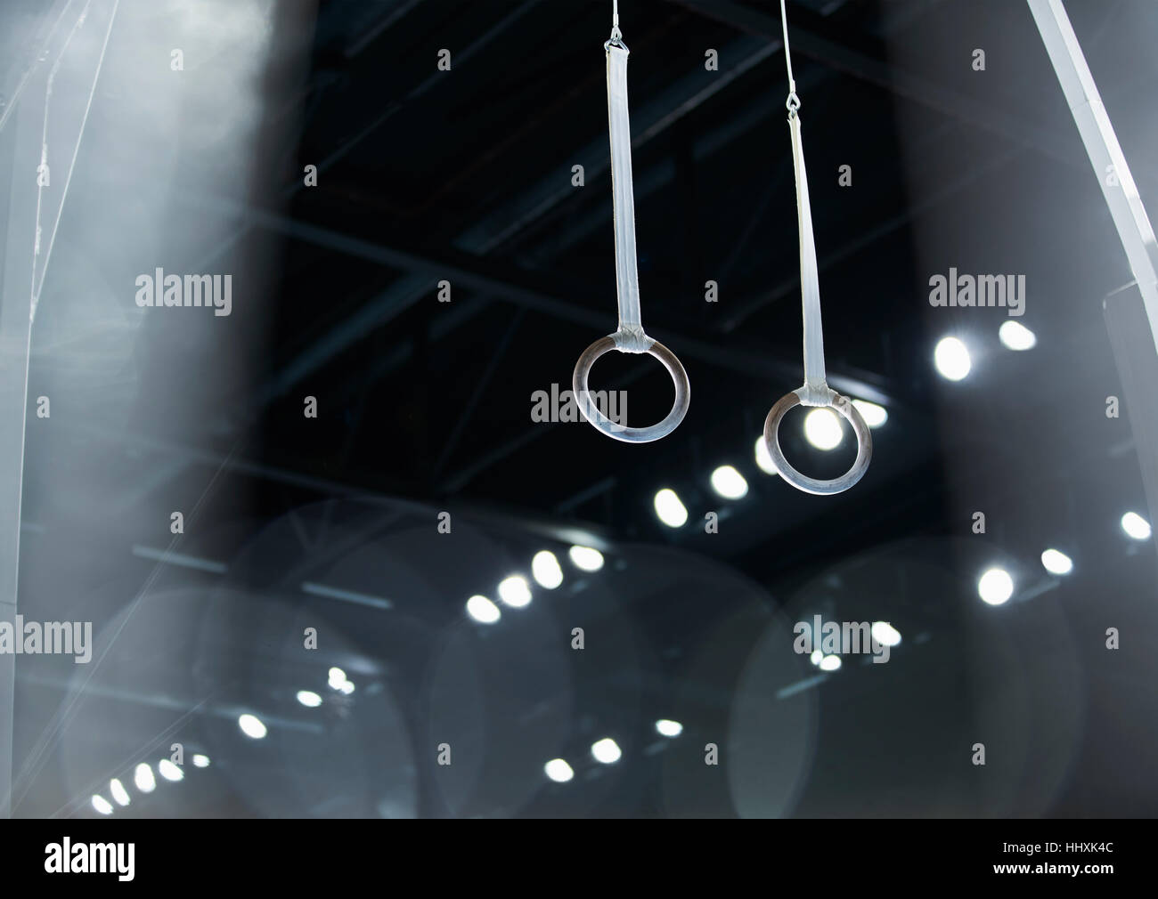 Gymnastics rings hanging in arena Stock Photo - Alamy