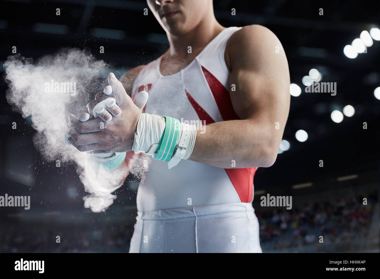 Male gymnast applying chalk powder to hands Stock Photo - Alamy