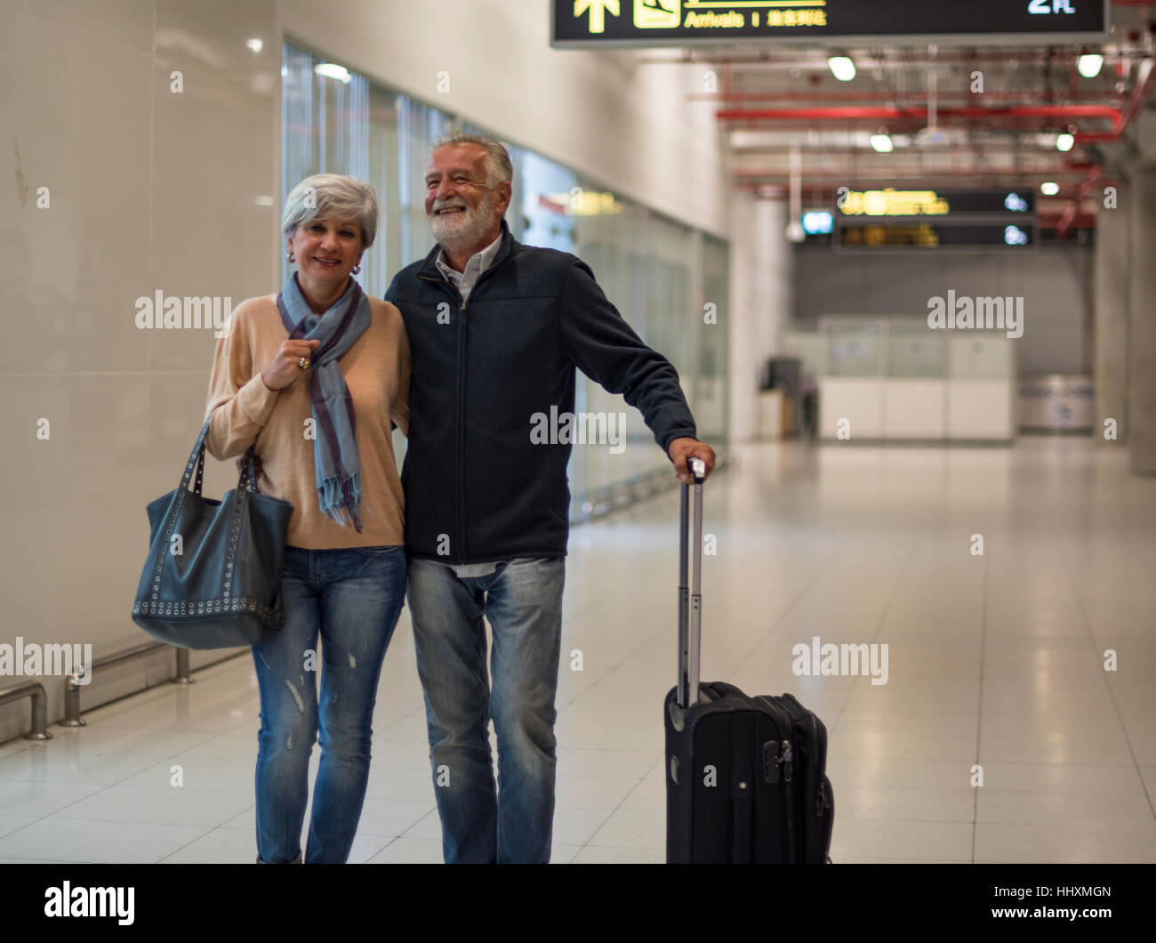 Senior couple traveling airport scene Stock Photo - Alamy
