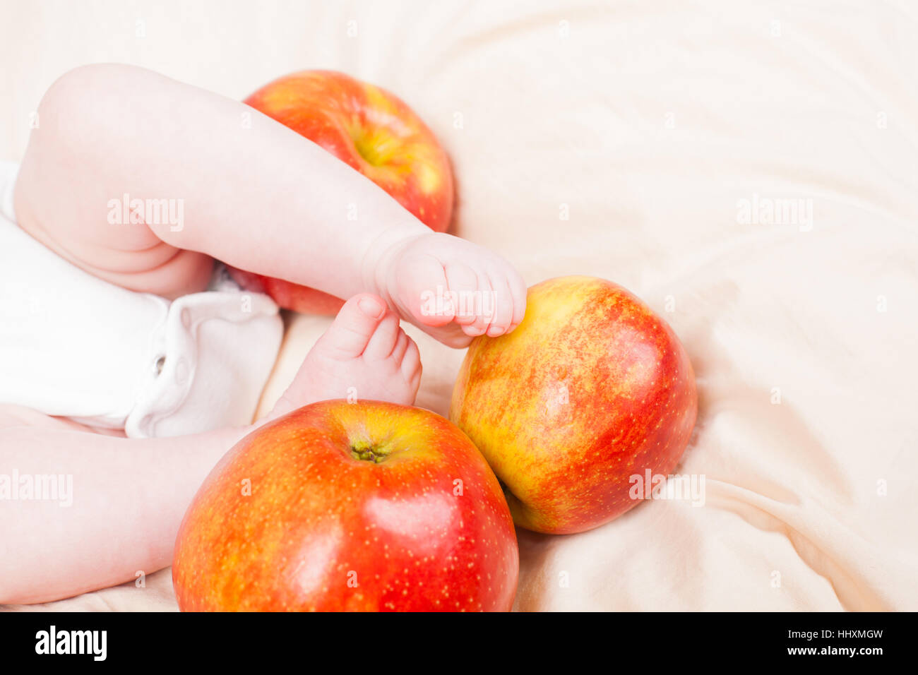 baby legs and red ripe apples Stock Photo - Alamy