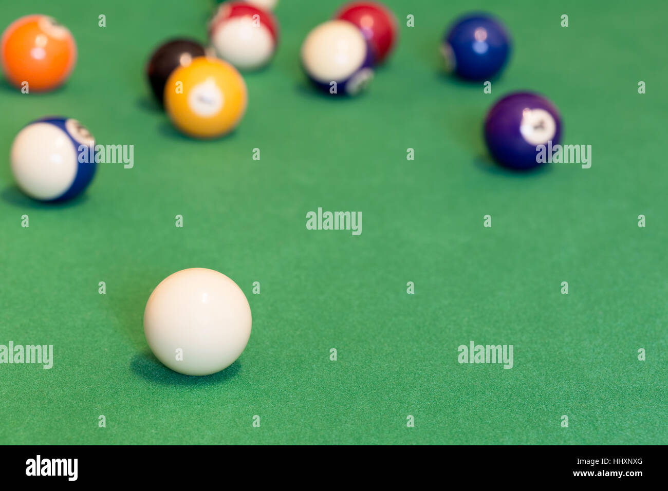 Pool balls on green baize table Stock Photo - Alamy