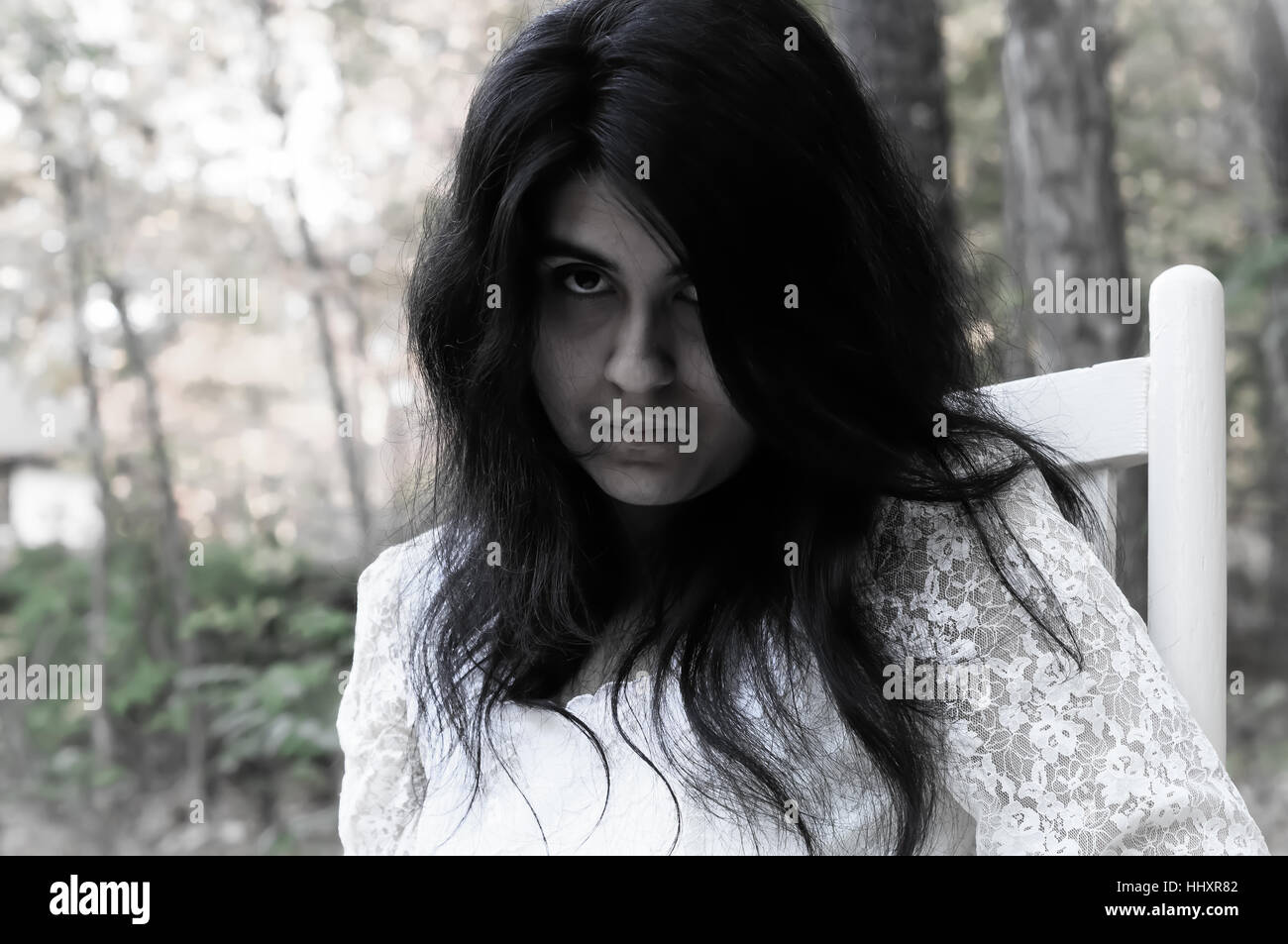 Teenage girl looking at the camera with a mad look Stock Photo - Alamy