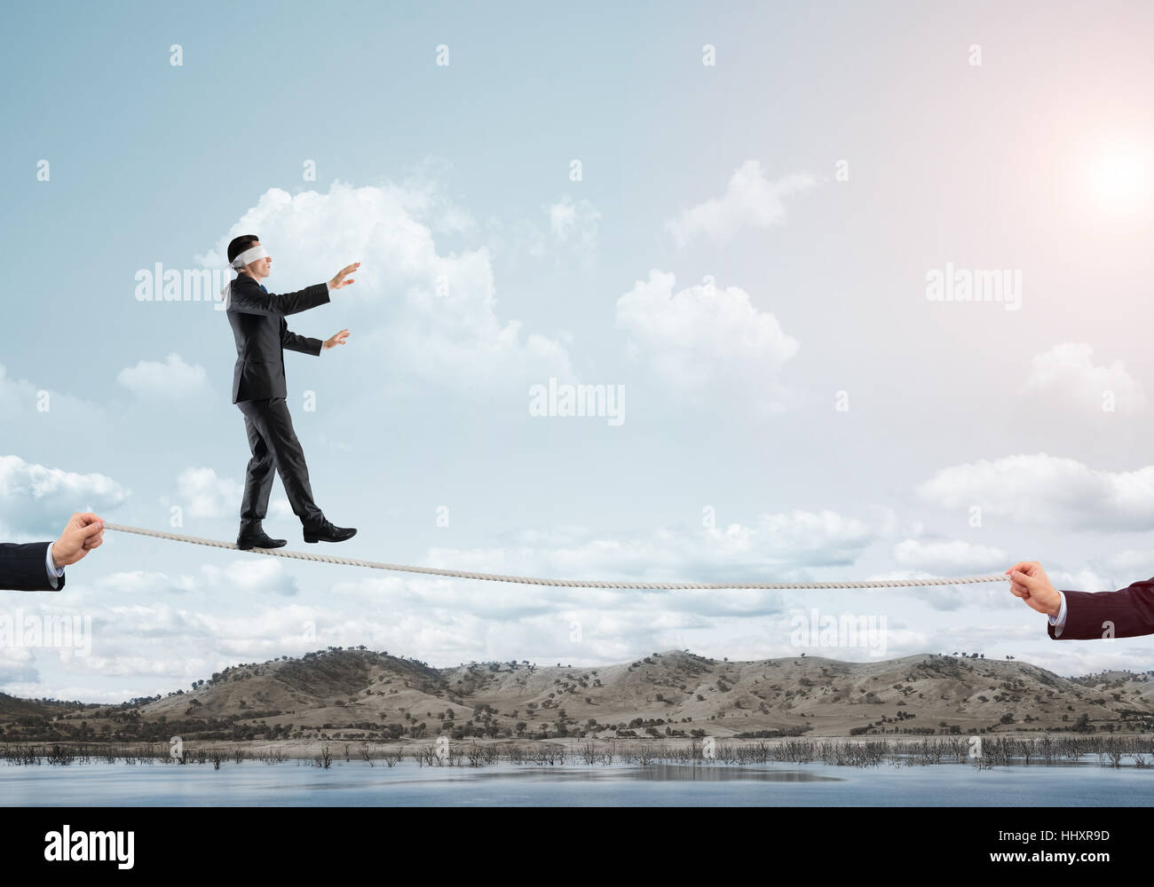 Business concept of risk support and assistance with man balancing on ...