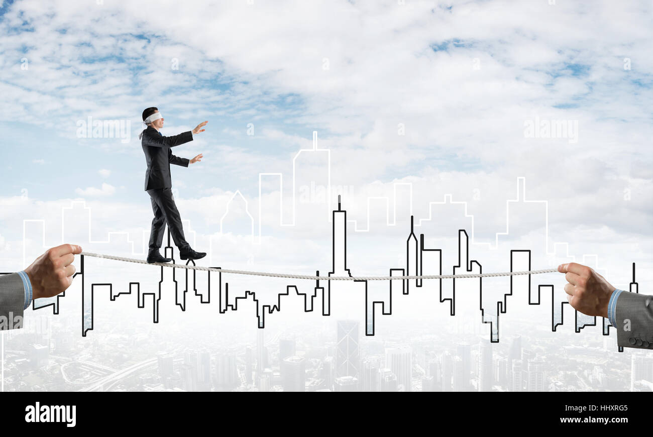 Business concept of risk support and assistance with man balancing on ...