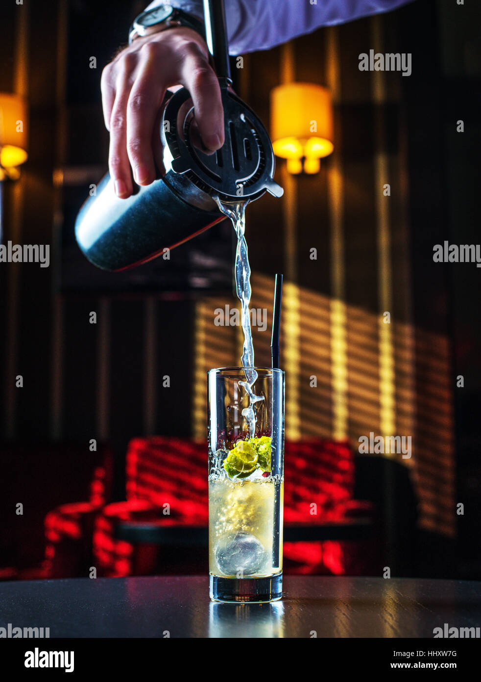 Barman at work, preparing cocktails. pouring Mai tai to cocktail glass ...
