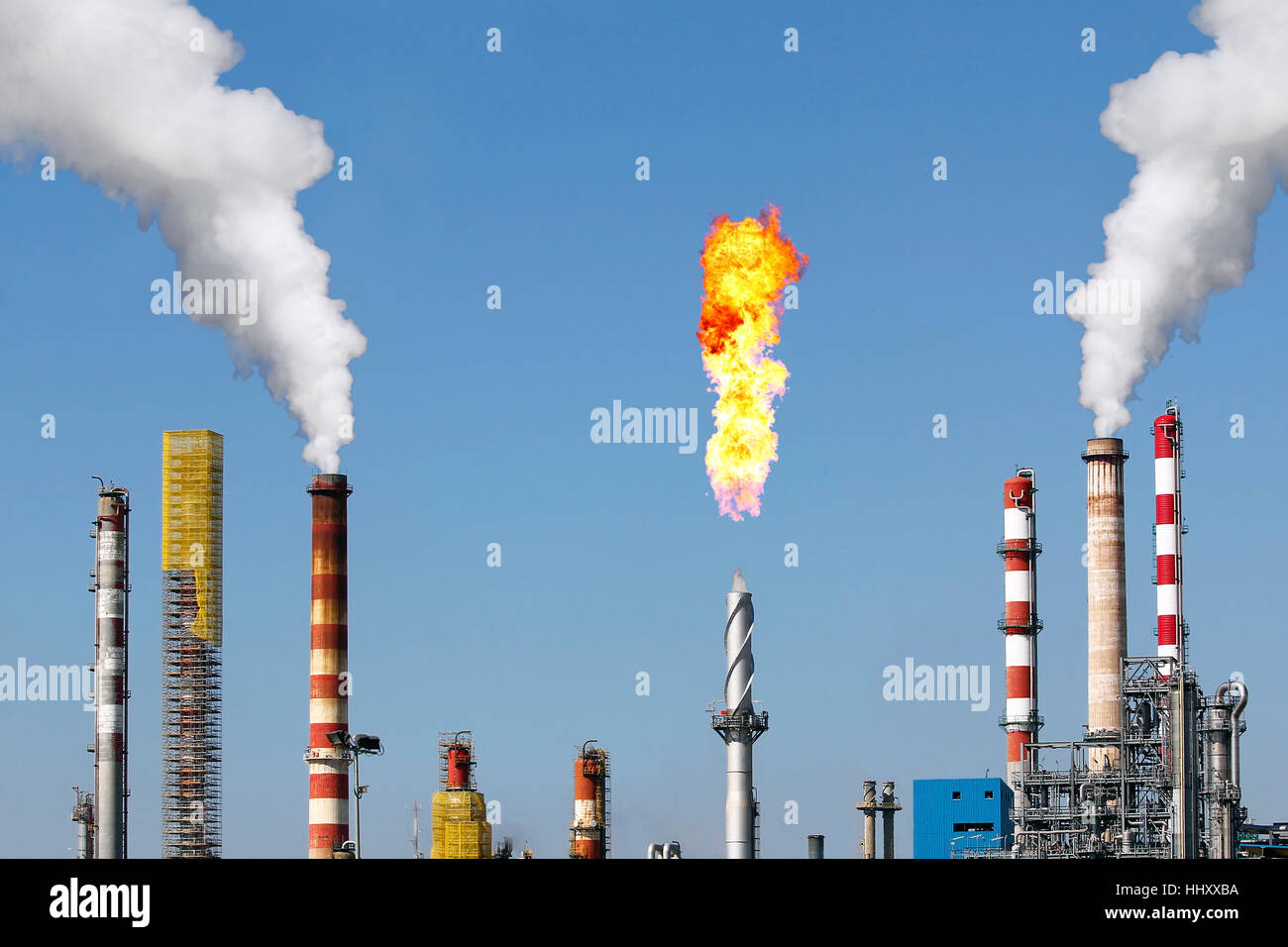 Smoke stacks and combustion gas torch in a large oil refinery Stock Photo - Alamy