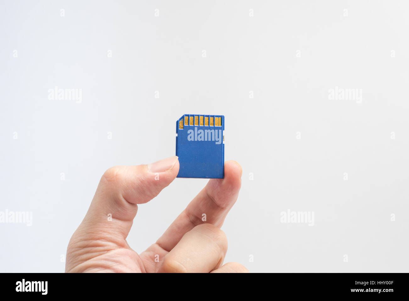 SD memory card with hand and finger hold isolate on white background ...