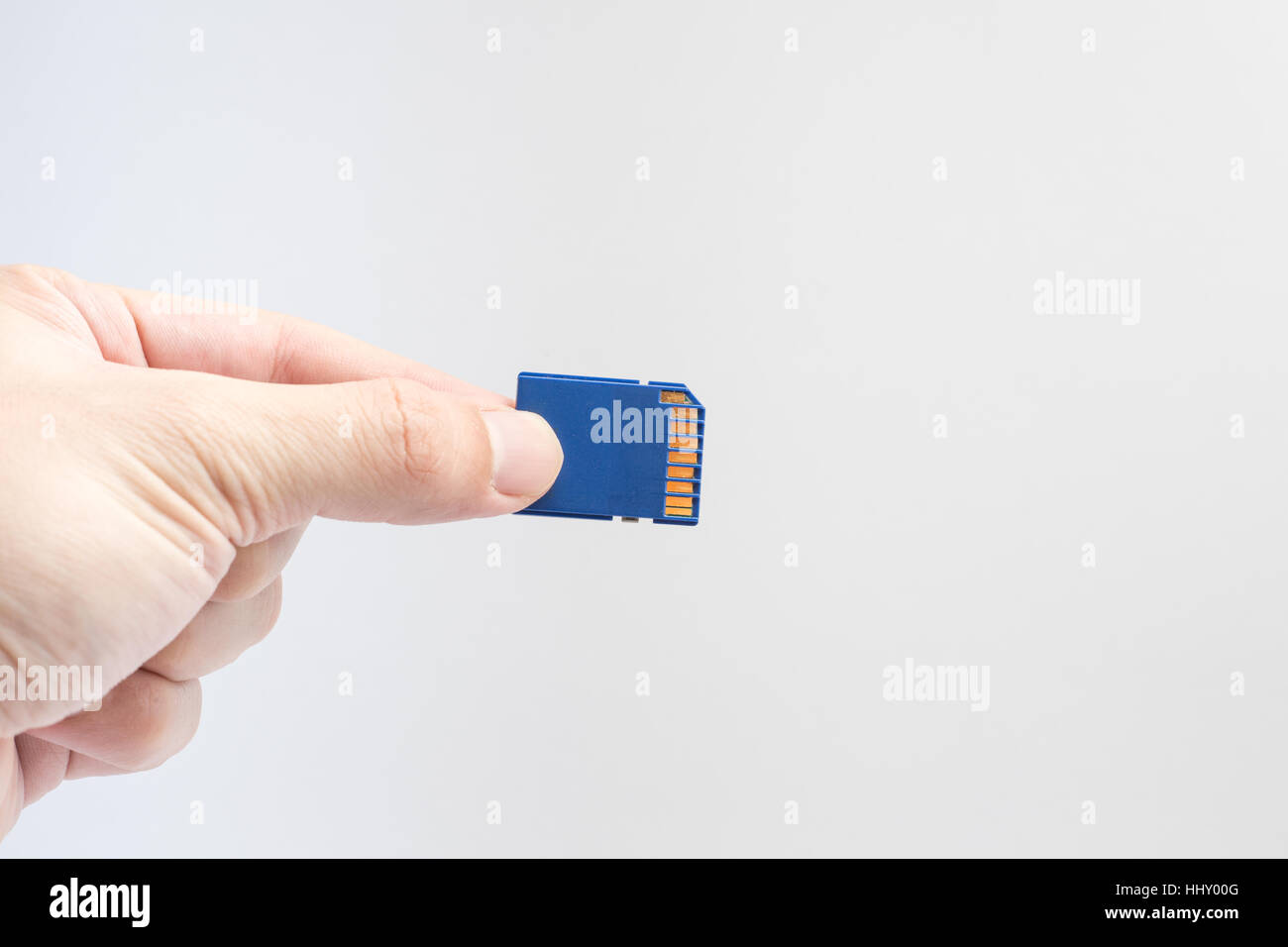 SD memory card with hand and finger hold isolate on white background ...
