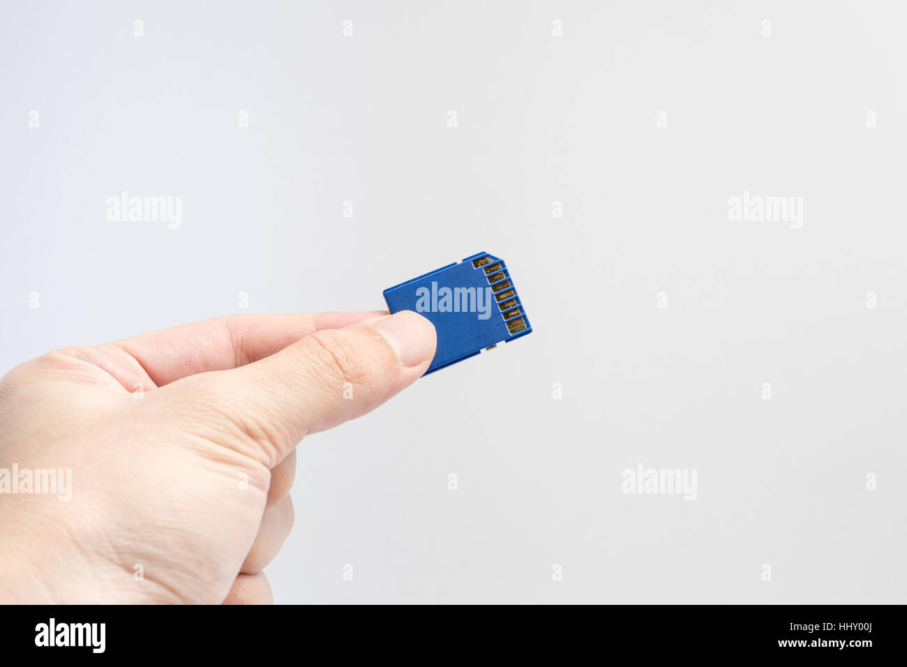 SD memory card with hand and finger hold isolate on white background ...
