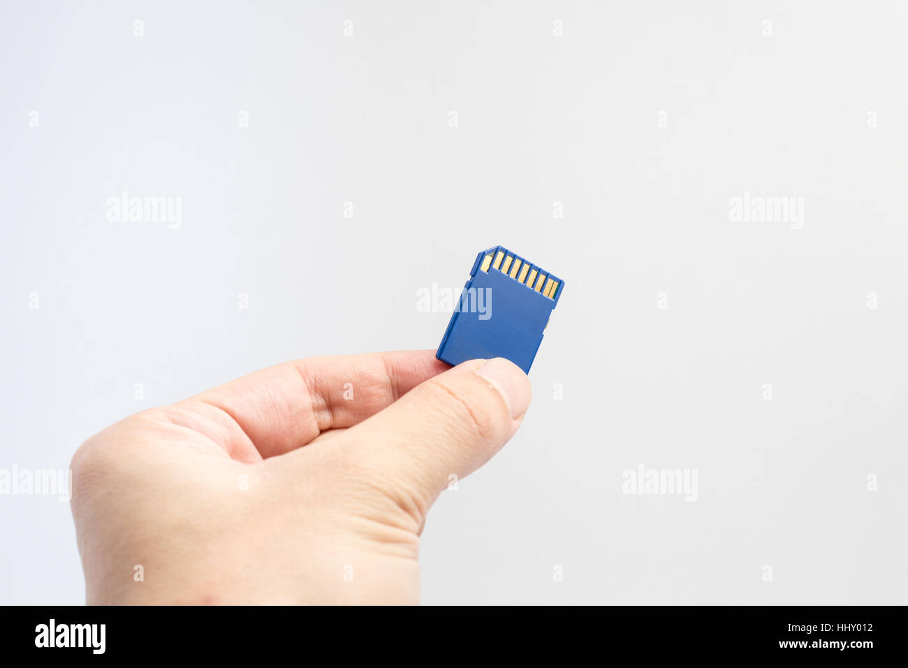 SD memory card with hand and finger hold isolate on white background ...
