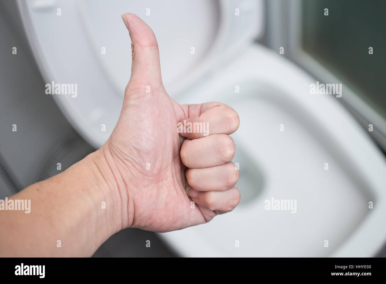 Thumb Up with background cleaning Toilets Bathroom Stock Photo - Alamy