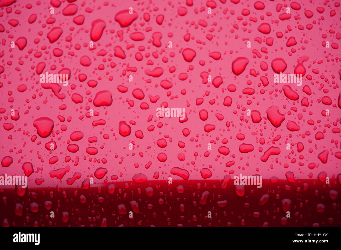 Droplets of rain on a red metallic background Stock Photo - Alamy