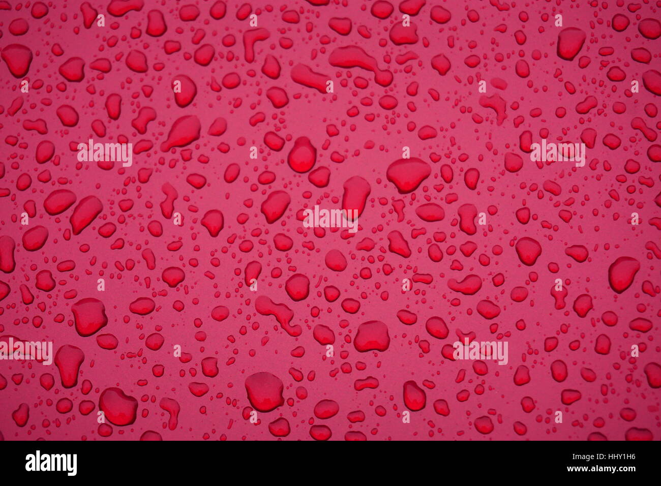 Droplets of rain on a red metallic background Stock Photo - Alamy