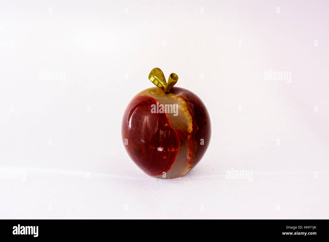 Apple made of onyx stone on a white background Stock Photo - Alamy