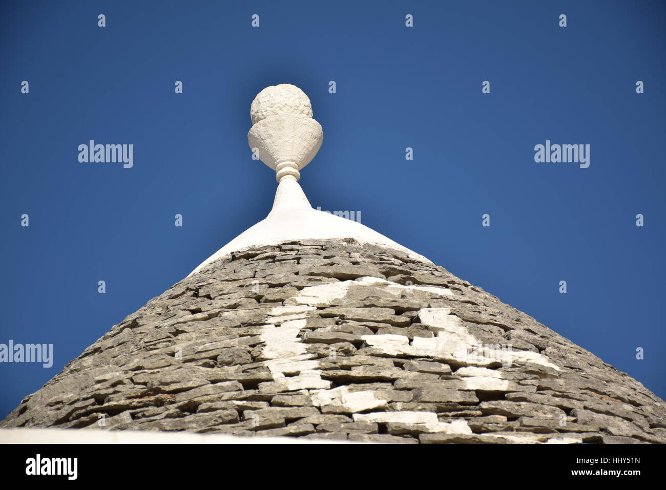 The typical conical roof of trulli houses and its symbols in ...