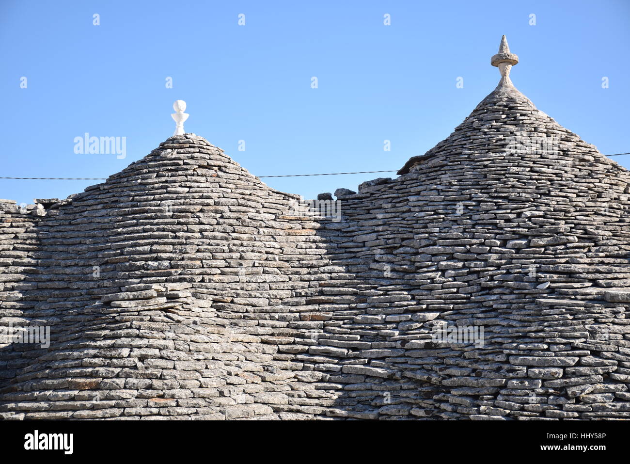 The typical conical roof of trulli houses and its symbols in ...