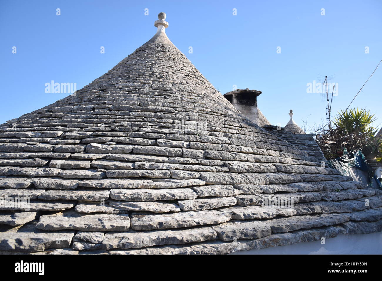 The typical conical roof of trulli houses and its symbols in ...