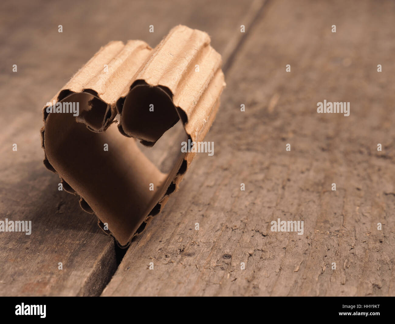 Love concept image with a cardboard heart shape on a rustic wooden ...