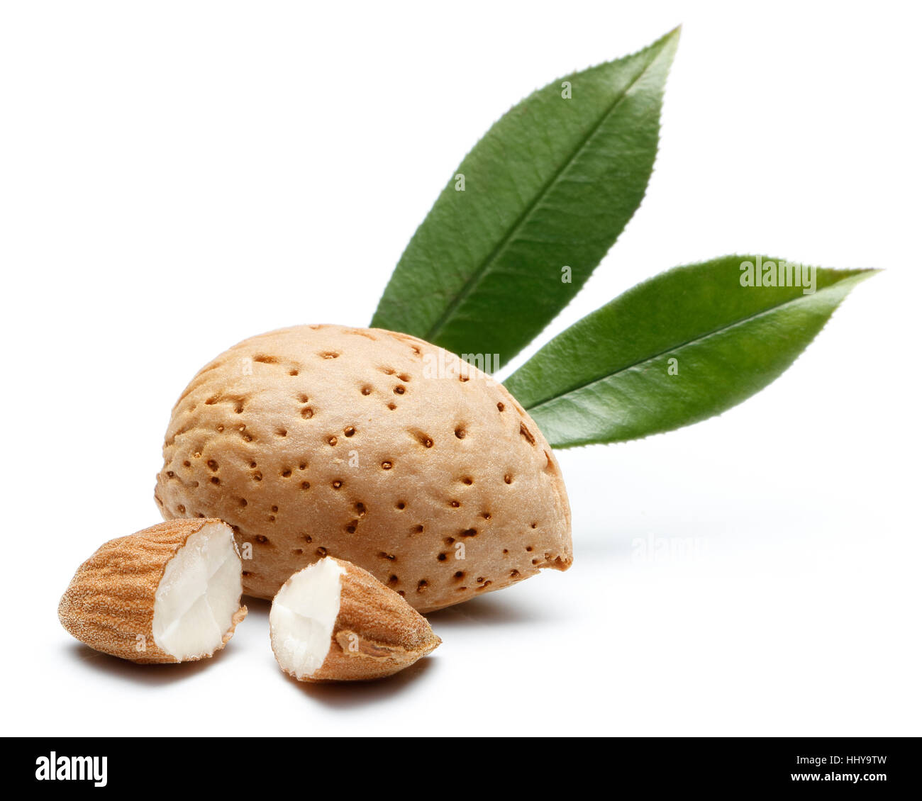 Almond, broken almond and leaves Stock Photo - Alamy