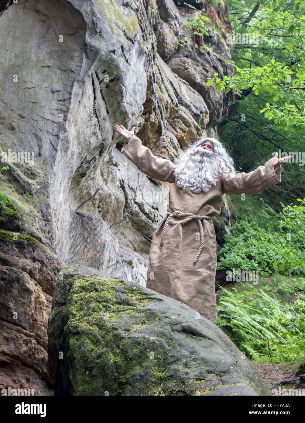 Bearded Man worshiping God in nature.The old hermit lifted up his hands ...