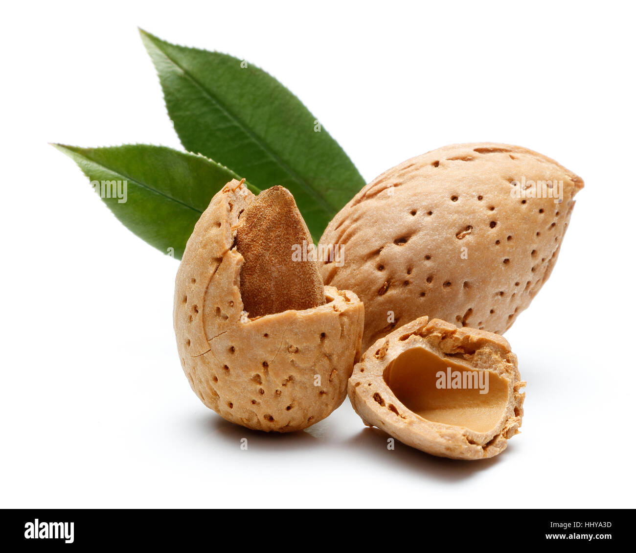 Almond, broken almond and leaves Stock Photo - Alamy