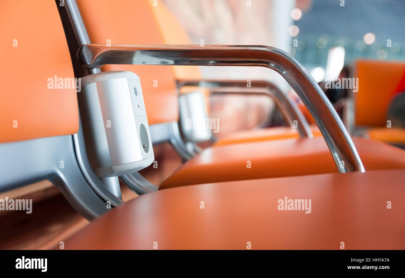 Chairs with electric outlet in airport Stock Photo - Alamy