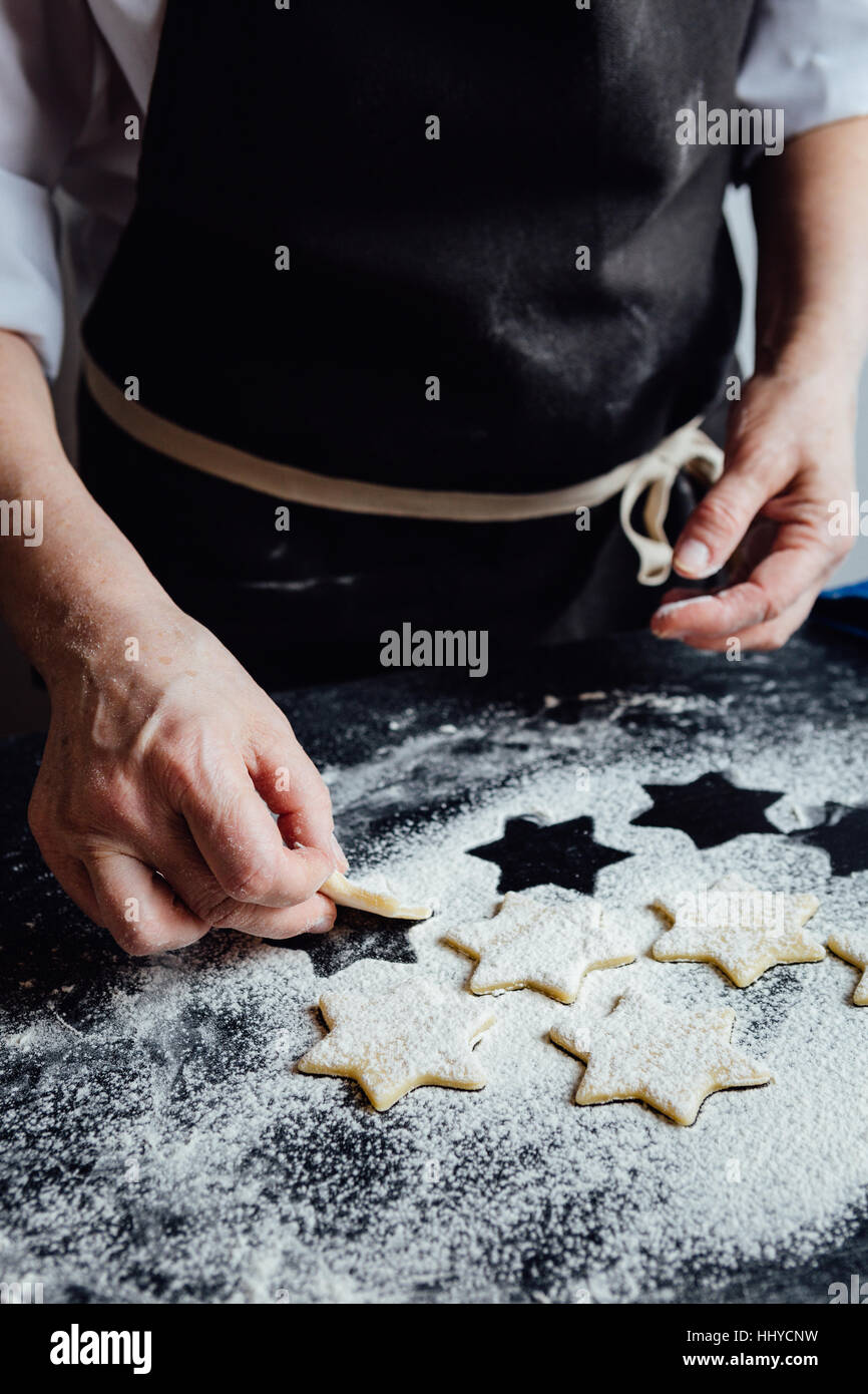 Person putting raw cookies to flour Stock Photo - Alamy