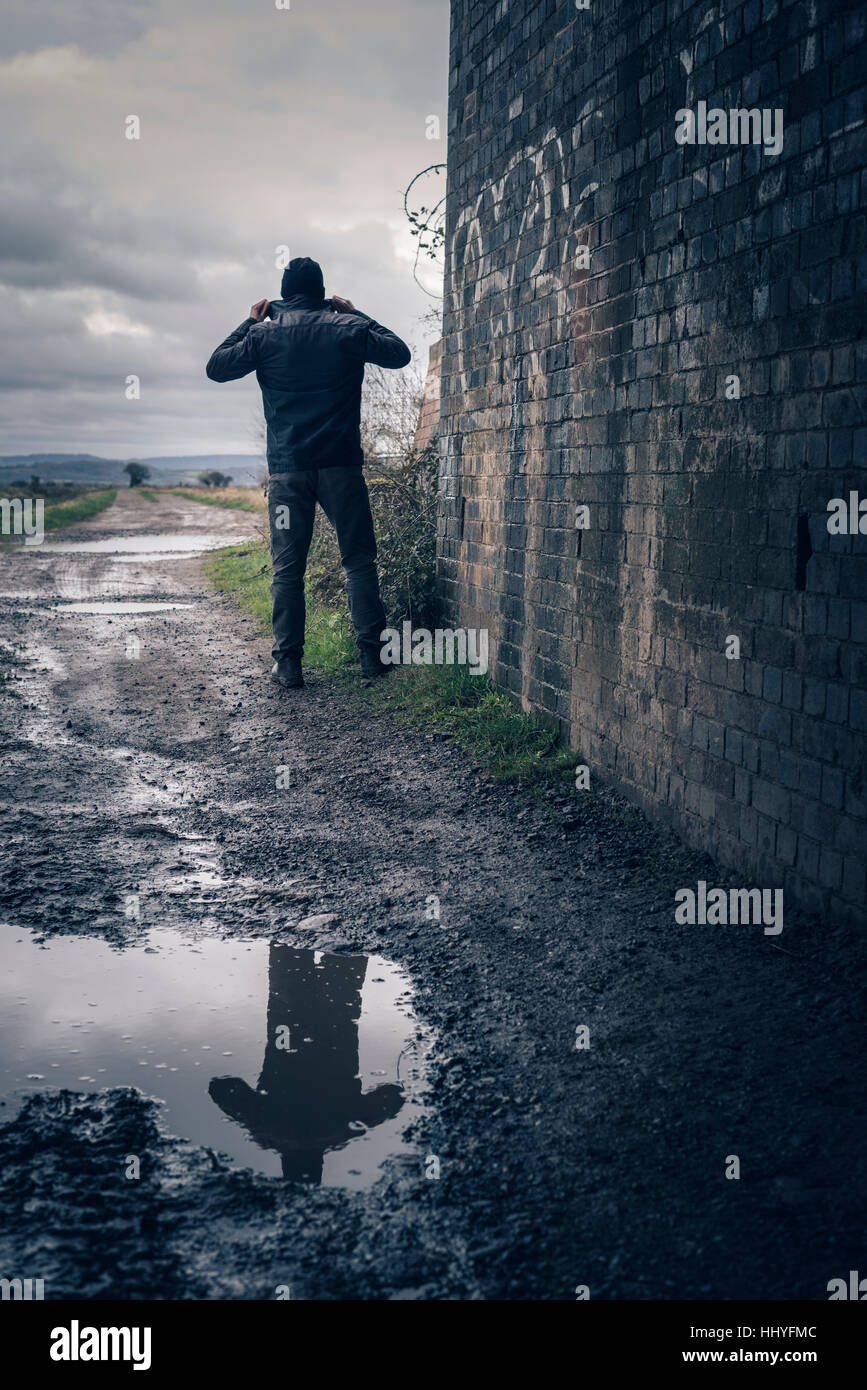 A man turns up the collar on his jacket, before setting off in bleak ...