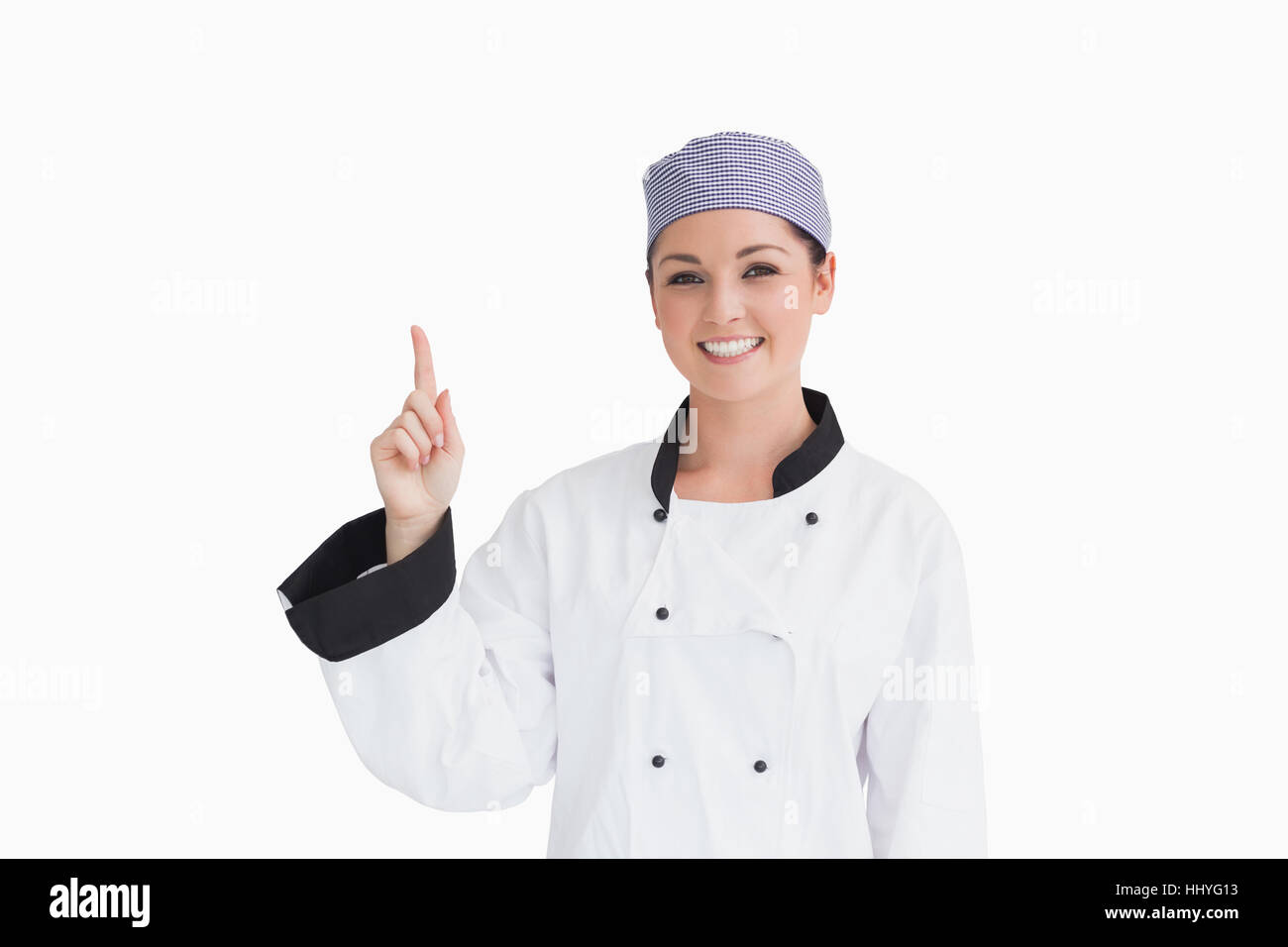 Smiling chef pointing up on white background Stock Photo - Alamy