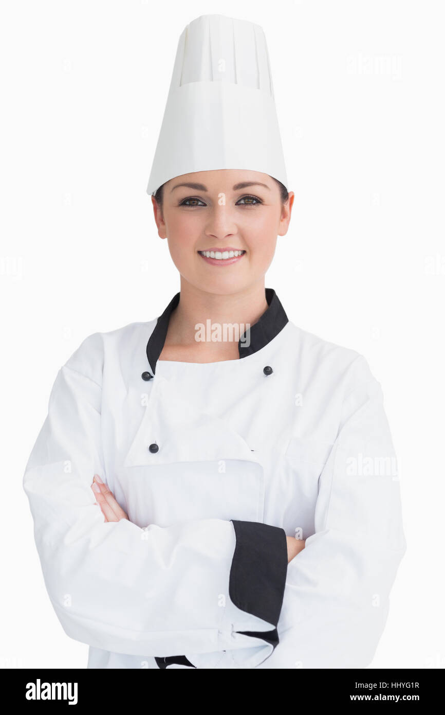 Smiling and standing cook wearing a chef hat in front of camera Stock ...