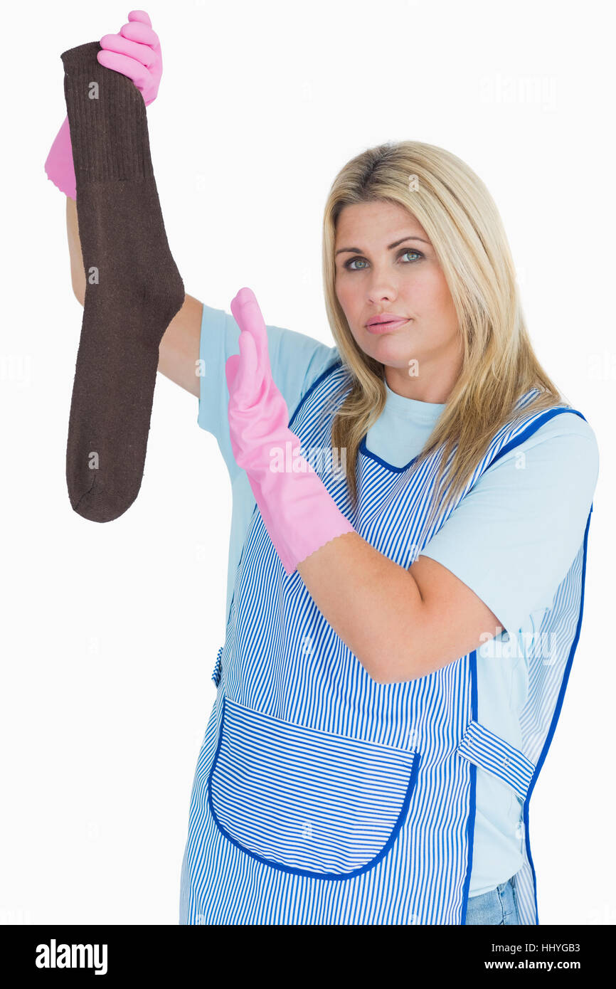 Cleaning woman holding a dirty sock in the white background Stock Photo ...