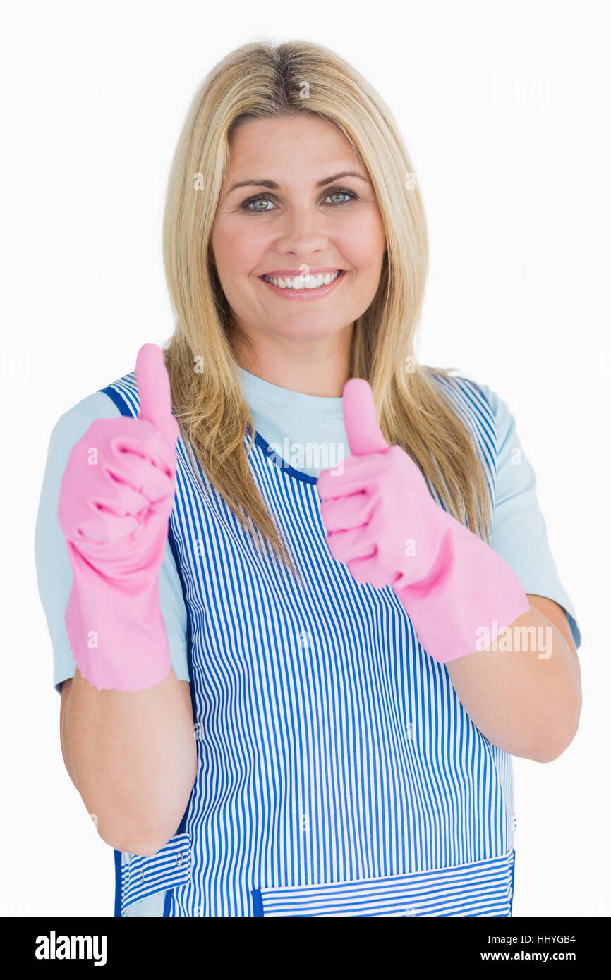 Cleaner putting thumbs up with pink gloves in the white background ...