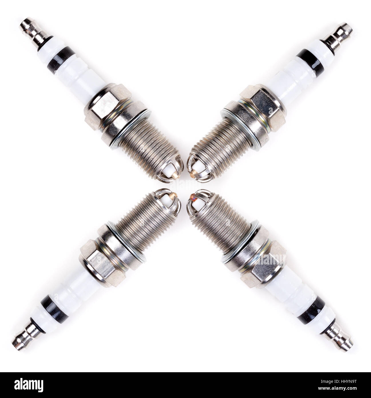 Set of four spark plugs arranged in a cross on a white background Stock ...