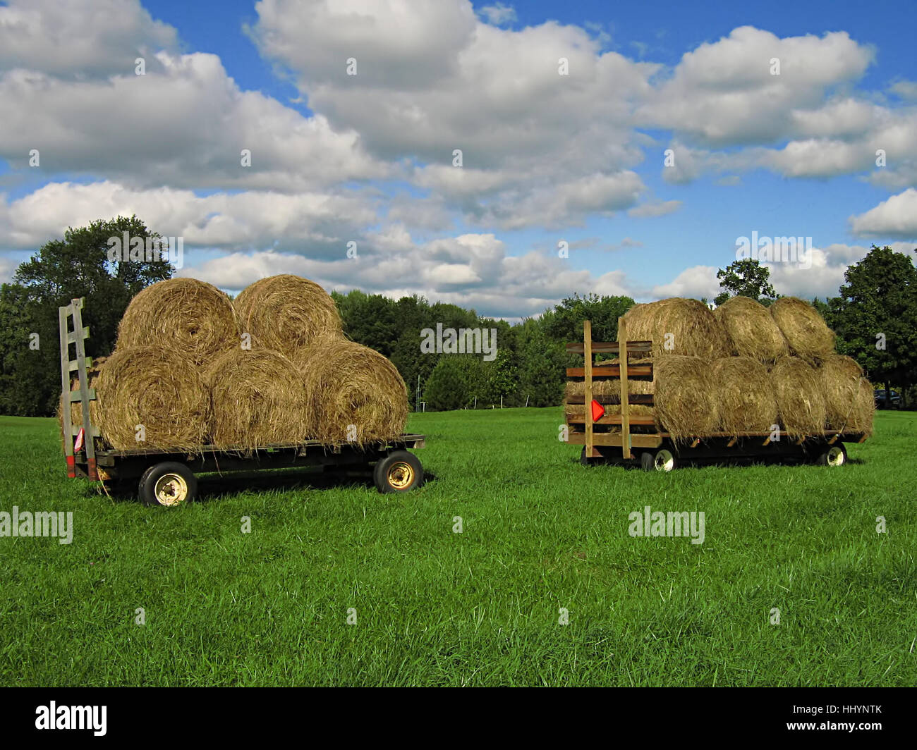 A photograph of two farm wagons loaded with hay Stock Photo - Alamy