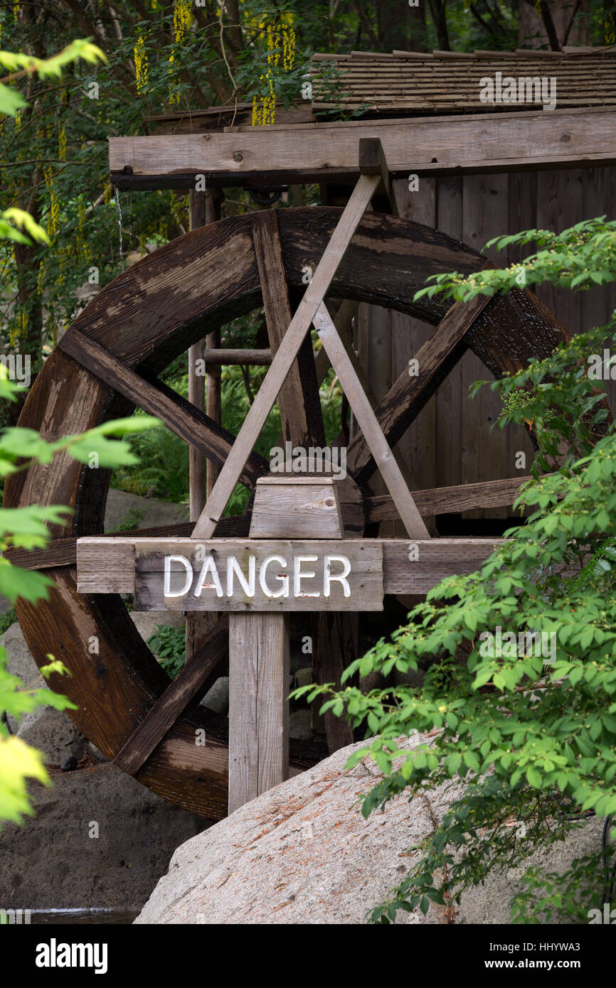 Danger sign on wooden waterwheel Stock Photo - Alamy