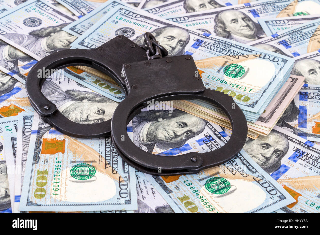 Police steel handcuffs lying on the heap of american dollars Stock ...