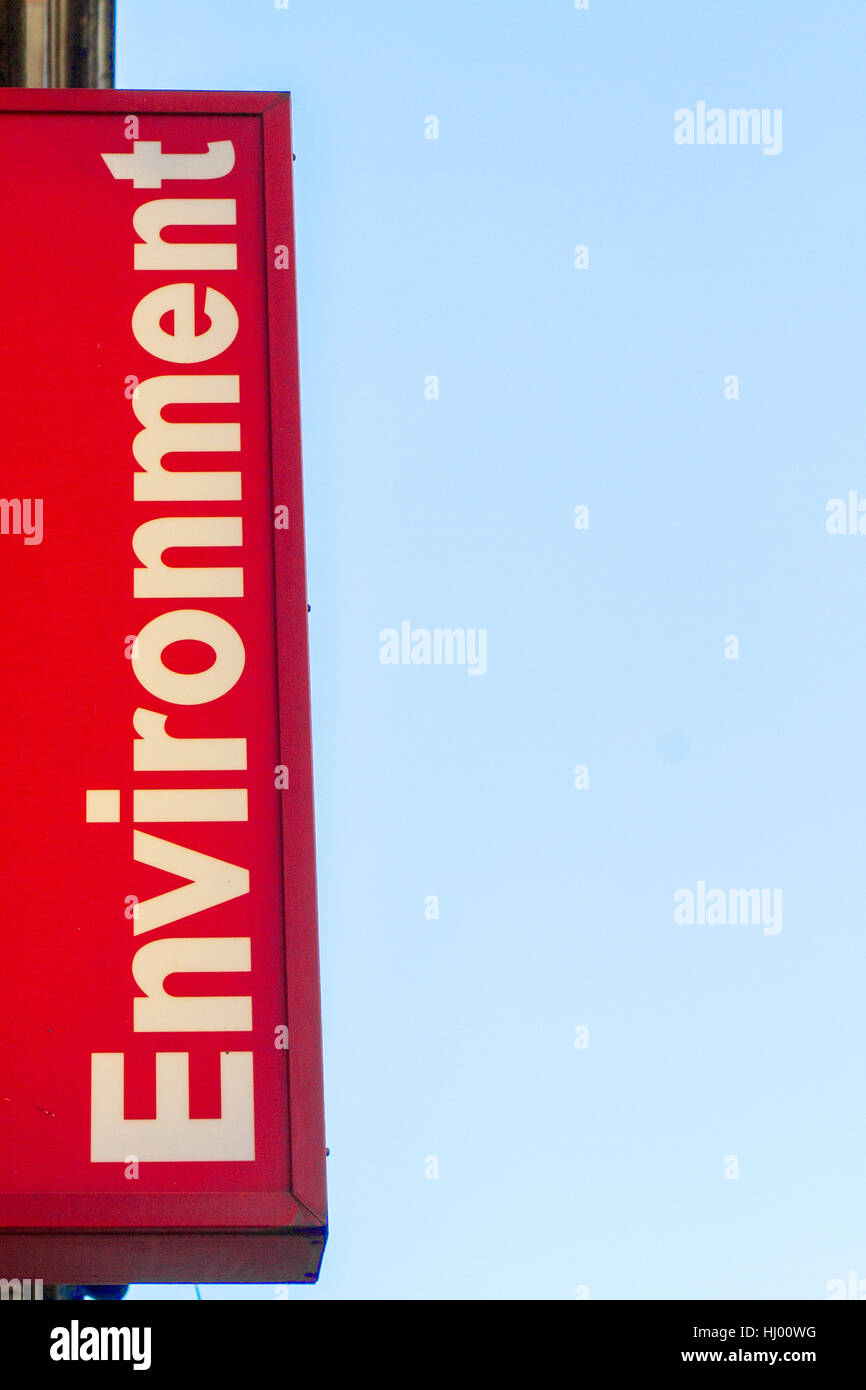 Red Environment Sign hanging vertically Stock Photo - Alamy