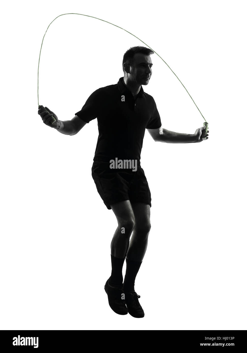 one man exercising jumping rope in studio silhouette isolated on white ...
