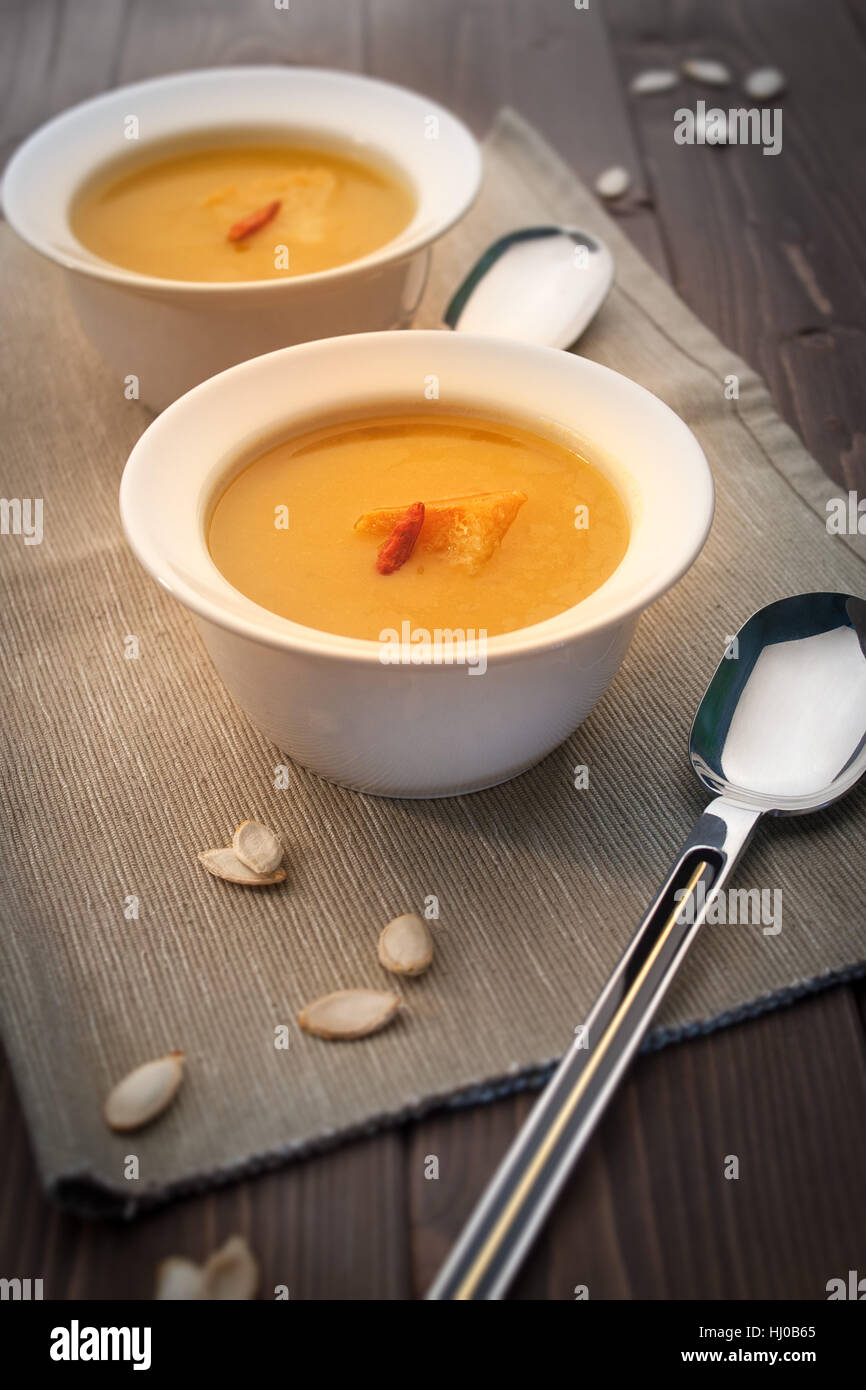 Bowl of hot pumpkin soup with chili pepper Stock Photo - Alamy