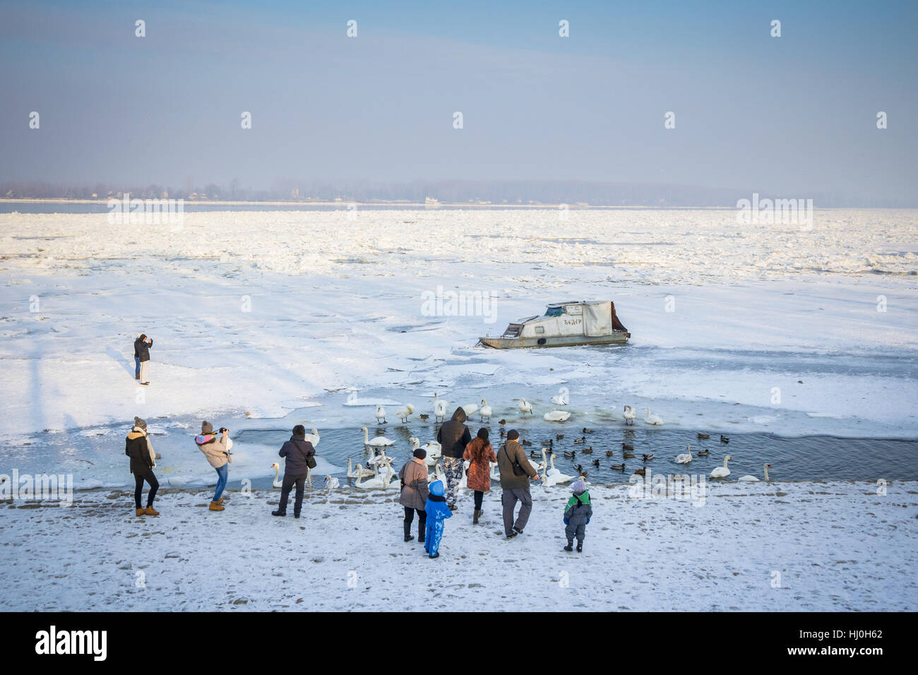 People walking and observing the frozen Danube in Belgrade, Serbia ...