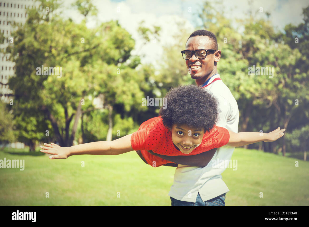 African American family having fun in the outdoor park during summer ...