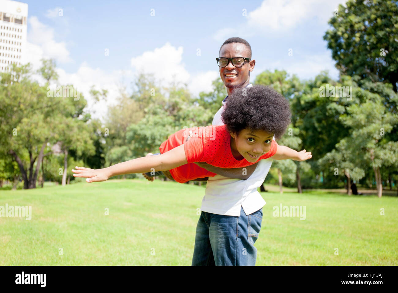 African American family having fun in the outdoor park during summer ...