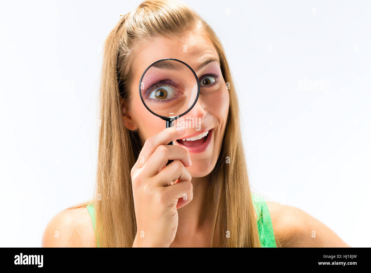 woman looks through magnifier magnifying glass Stock Photo - Alamy
