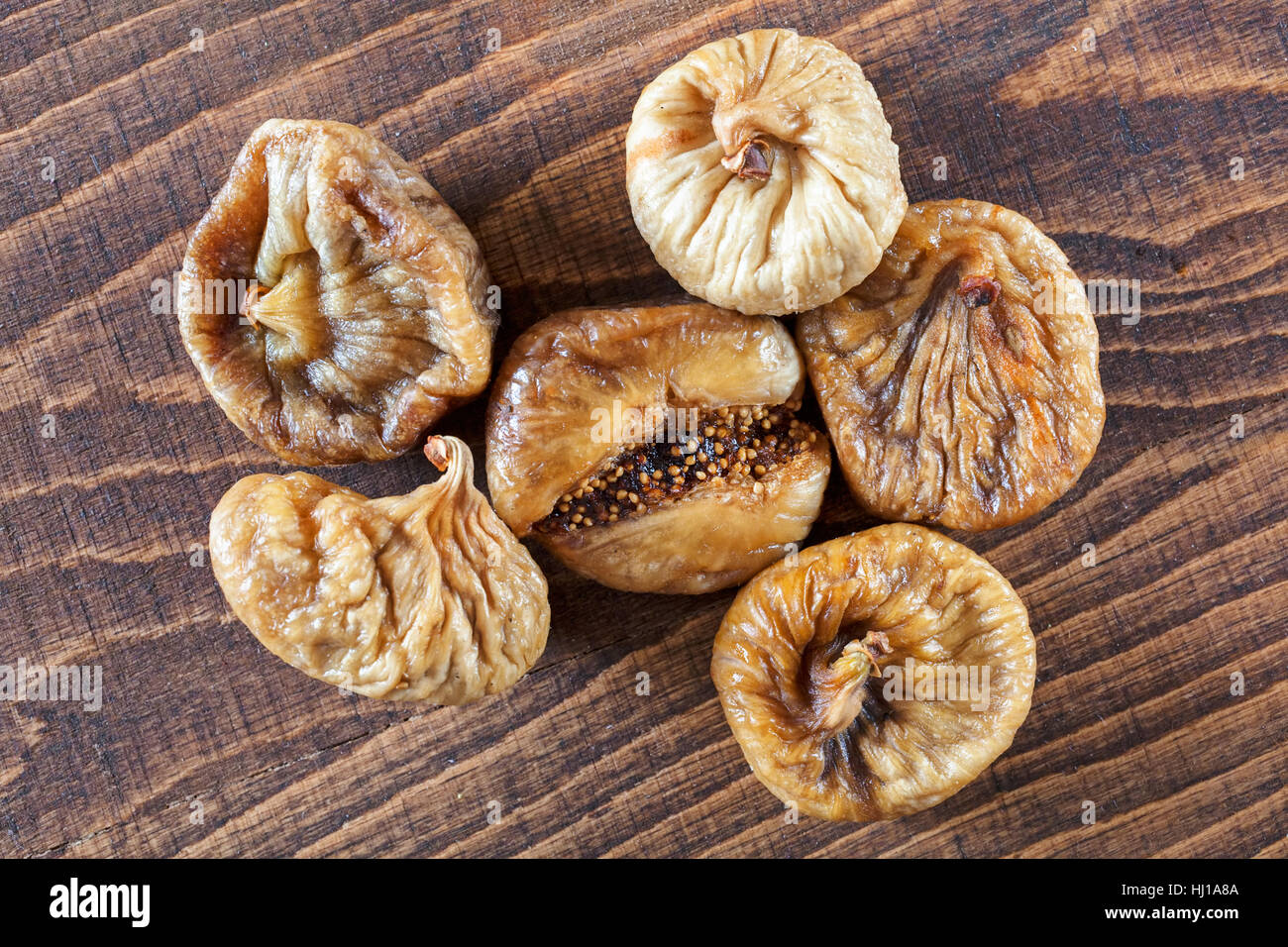 dried figs on a wooden table, note shallow depth of field Stock Photo ...