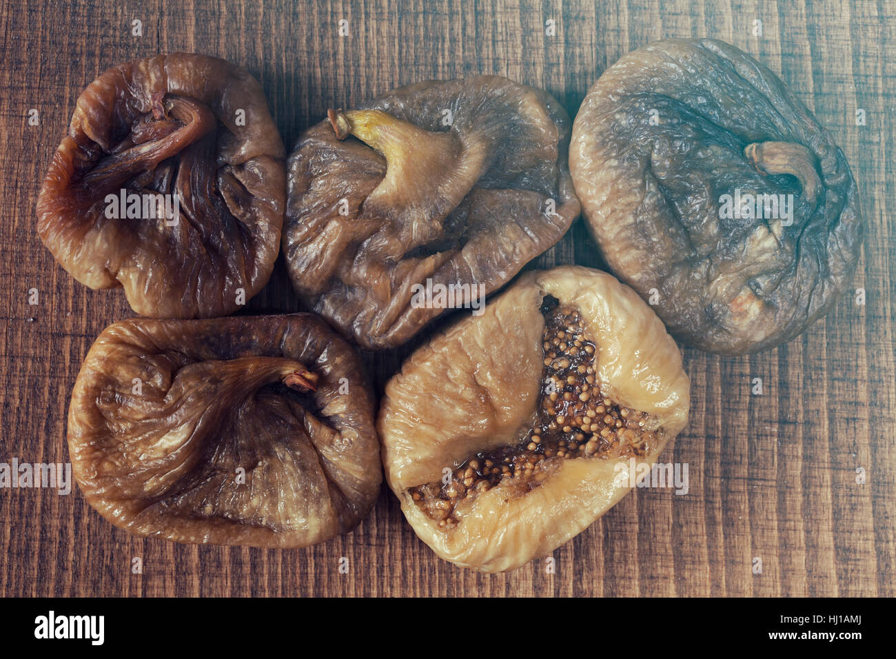dried figs on a wooden table, note shallow depth of field Stock Photo ...