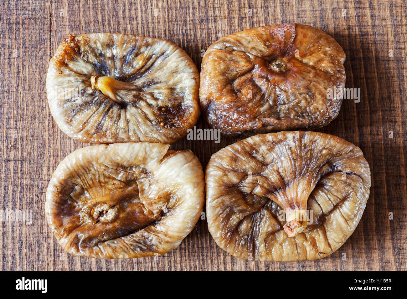 dried figs on a wooden table, note shallow depth of field Stock Photo ...