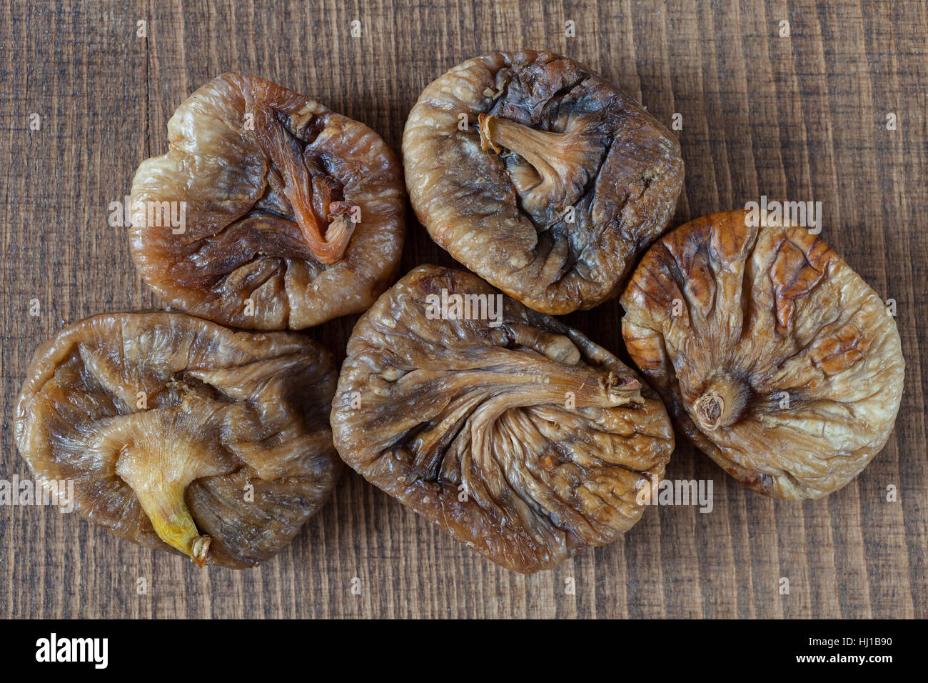 dried figs on a wooden table, note shallow depth of field Stock Photo ...