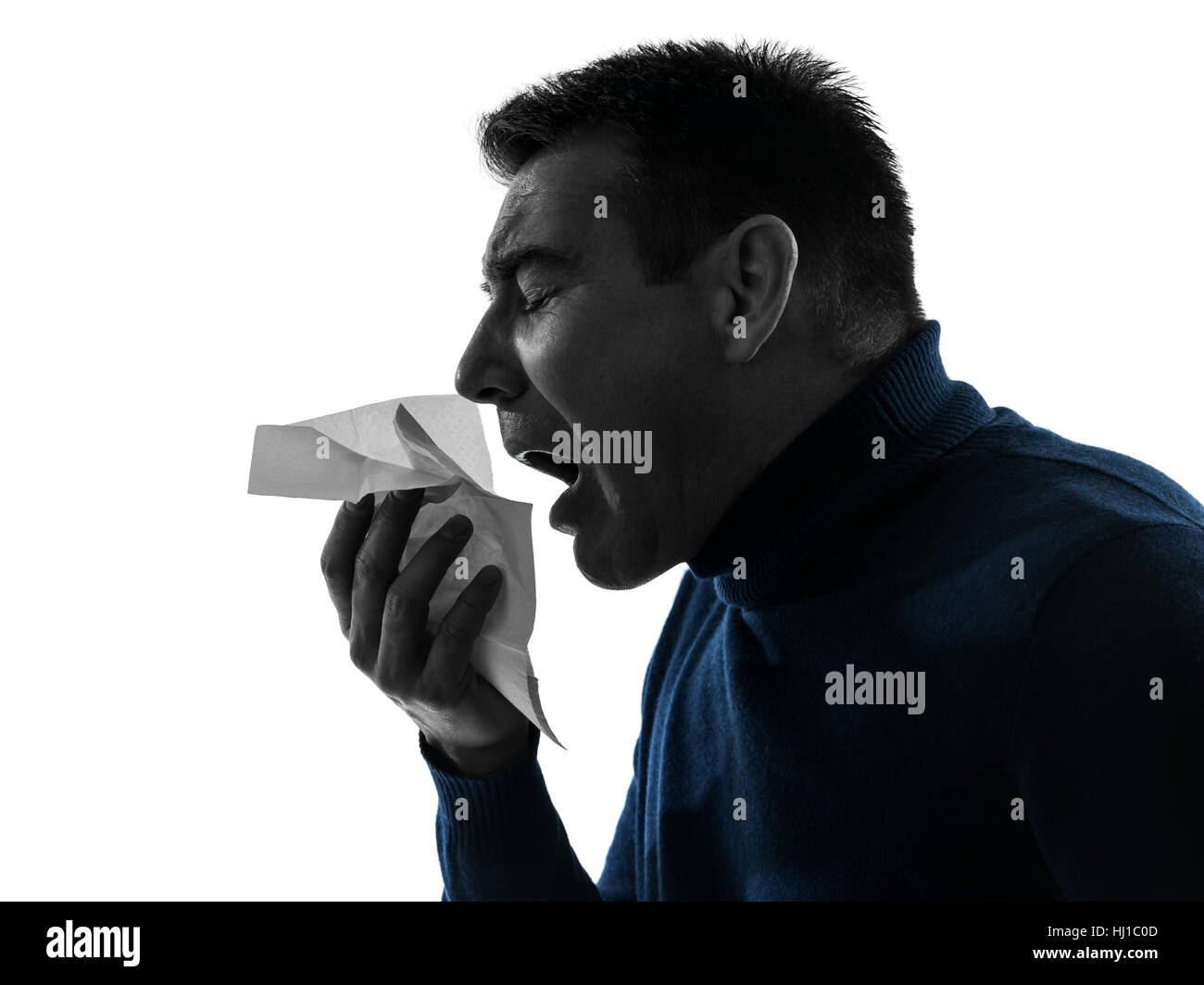 one causasian man sneezing portrait in silhouette studio isolated on ...